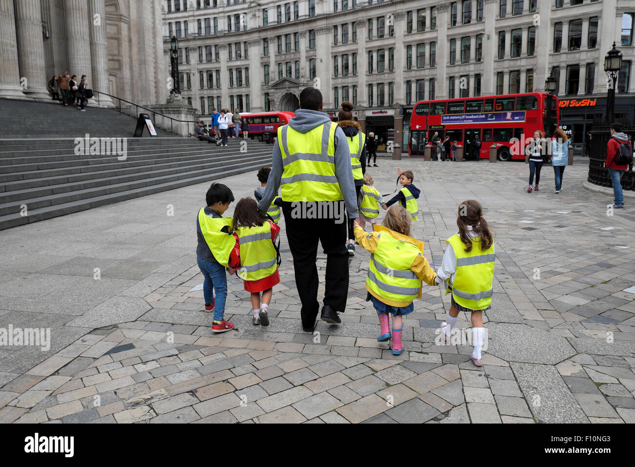 Nursery school children & child minders wearing high visibility Stock ...
