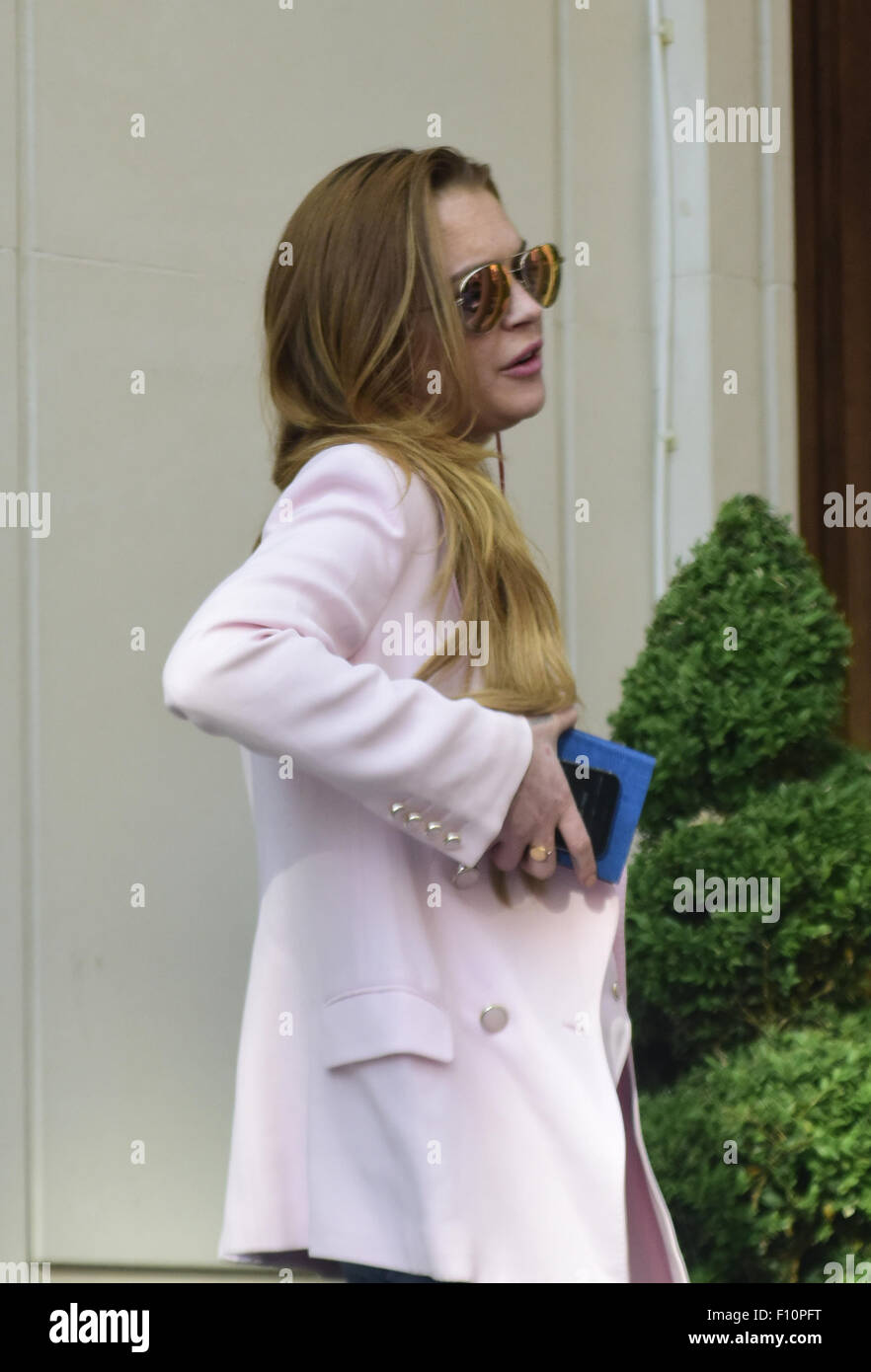 Lindsay Lohan seen in pink blazer outside a hotel smoking Featuring ...