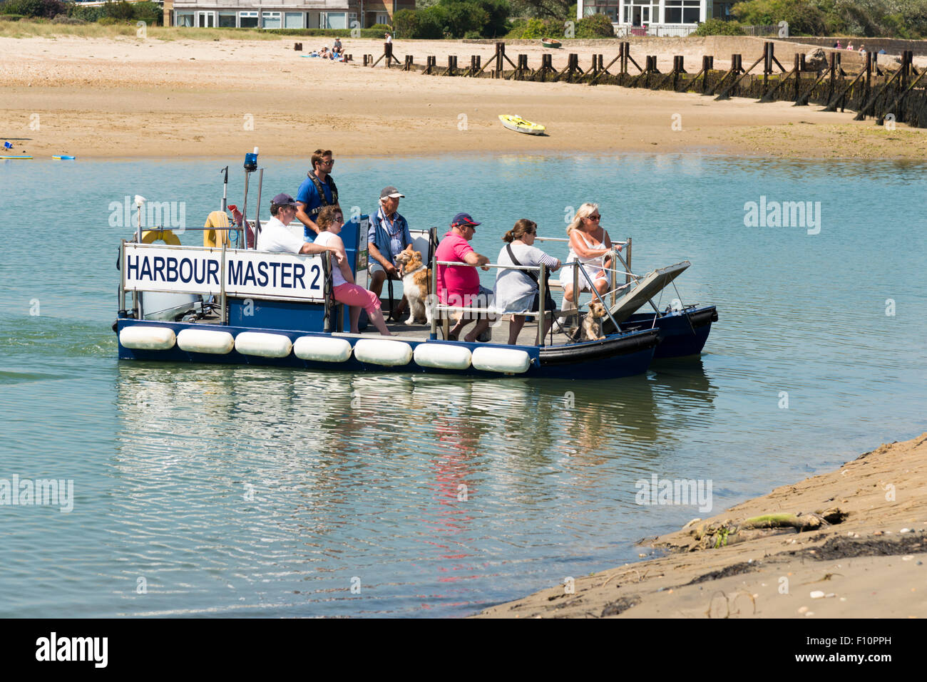 Passengers on a small ferry called Harbourmaster 2 at Bembridge on the ...