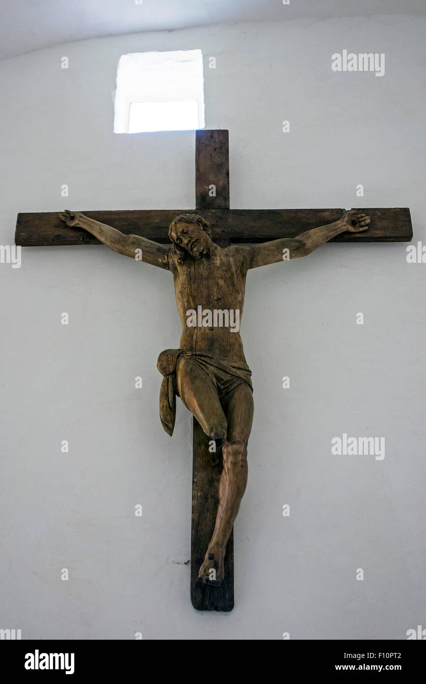 Wooden crucifix of Christ with charred feet in chapel of Château de ...