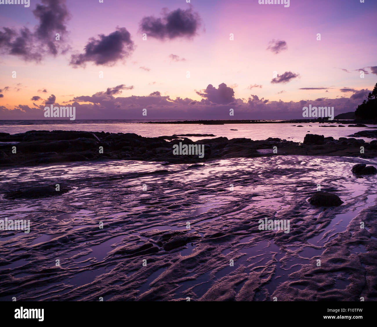 Beautiful rock patterns and sunrise at shore Stock Photo - Alamy