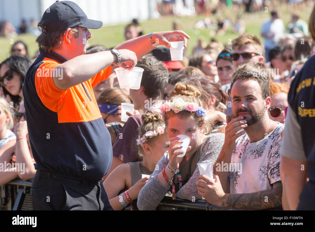 Security men handing out water to the crowd at the V Festival music ...
