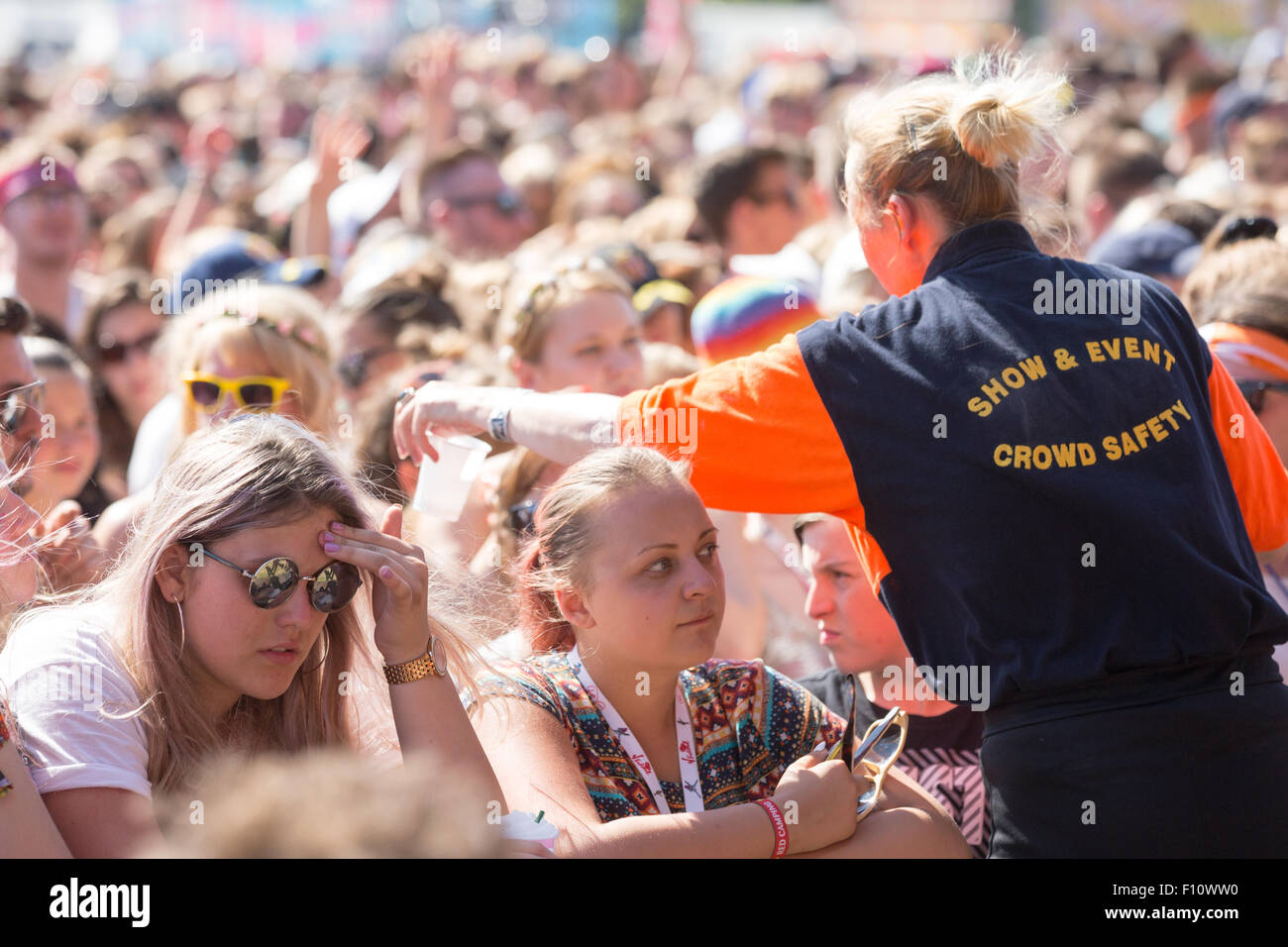 Security men handing out water to the crowd at the V Festival music ...
