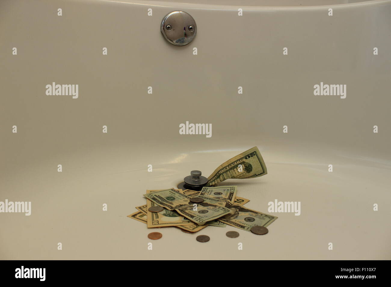 Money down drain hi-res stock photography and images - Alamy