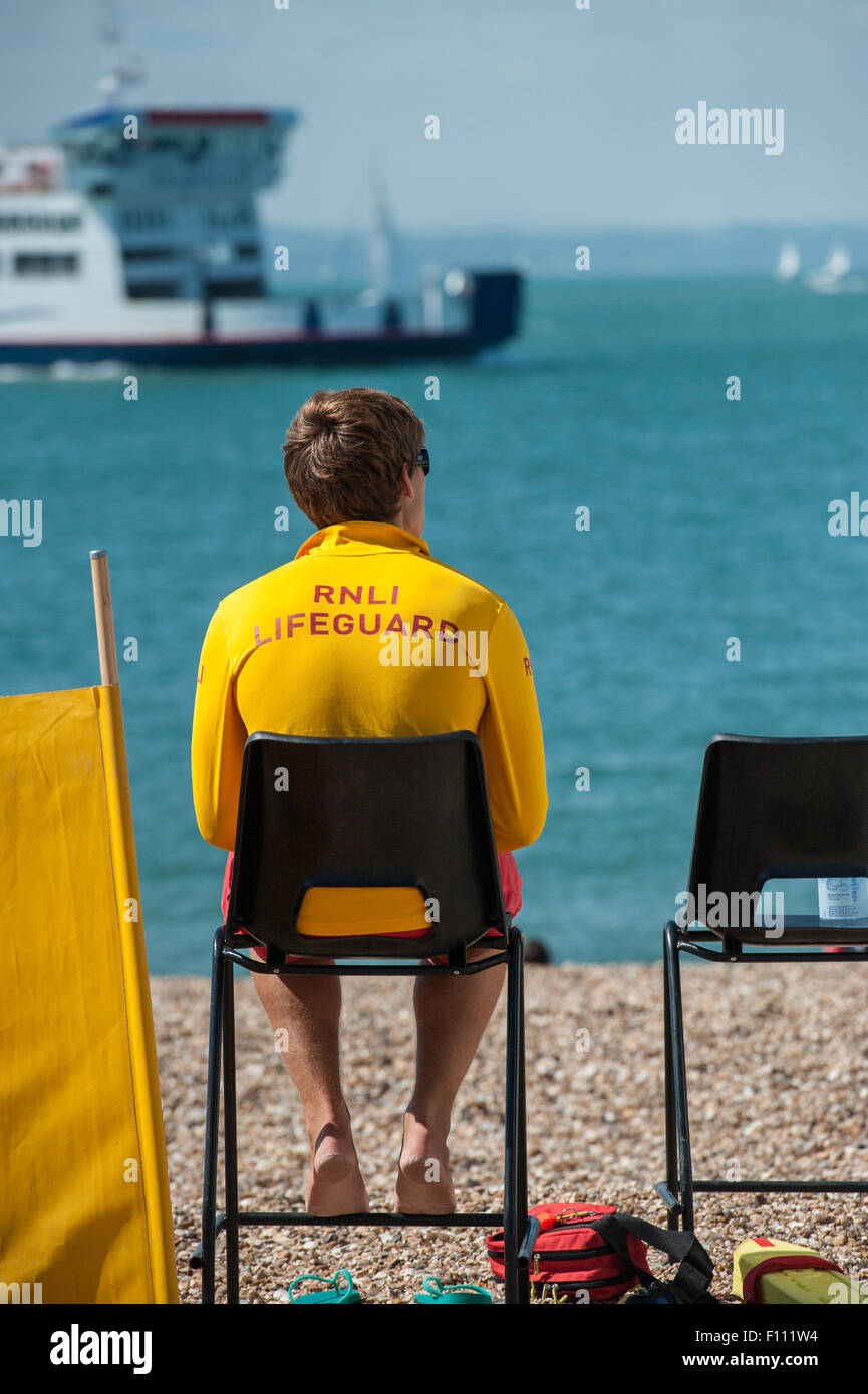 Royal Naval Lifeboat Institution lifeguard on duty on a beach in ...