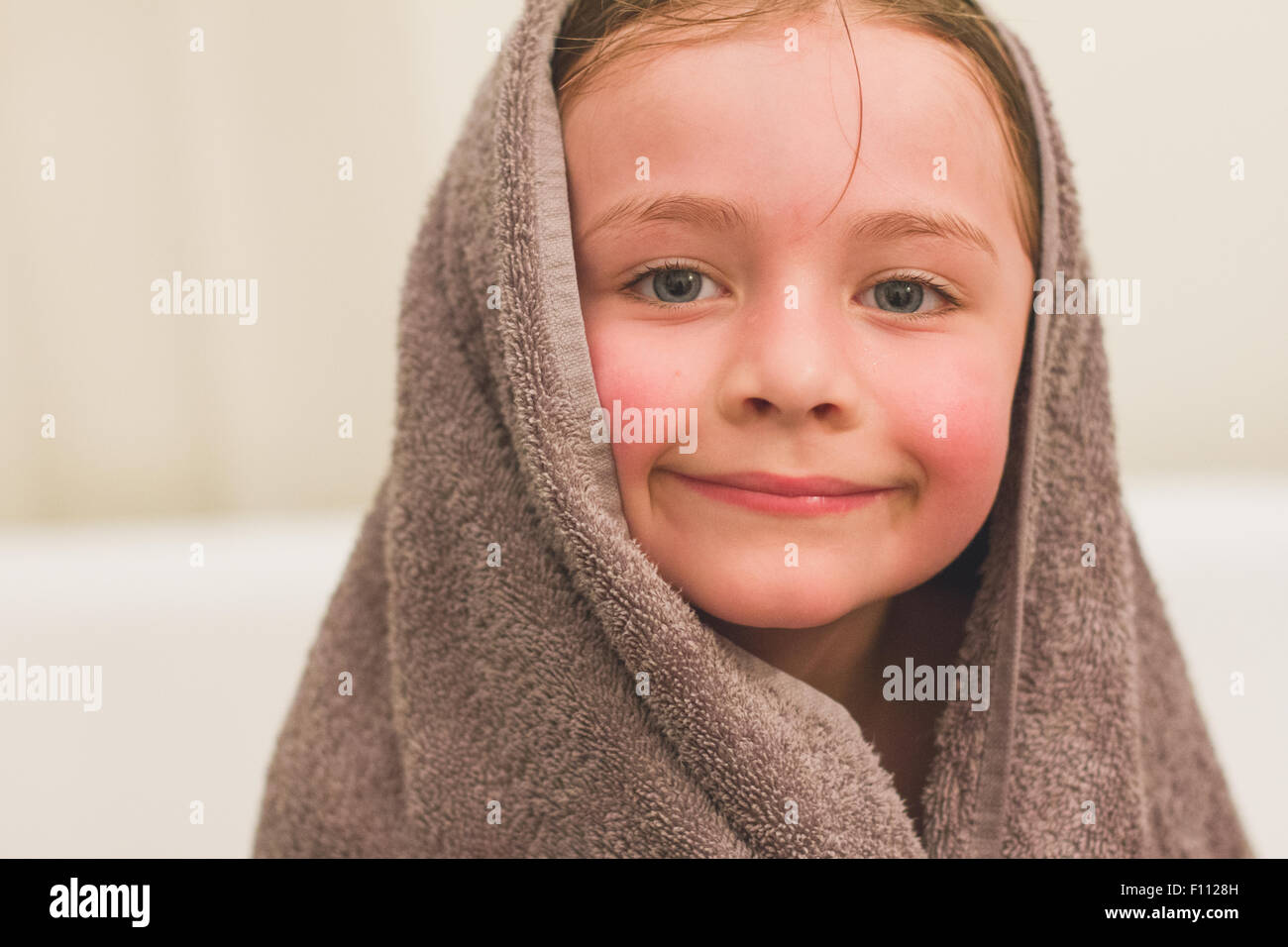 After bath time glow; boy is wrapped in a towel Stock Photo - Alamy