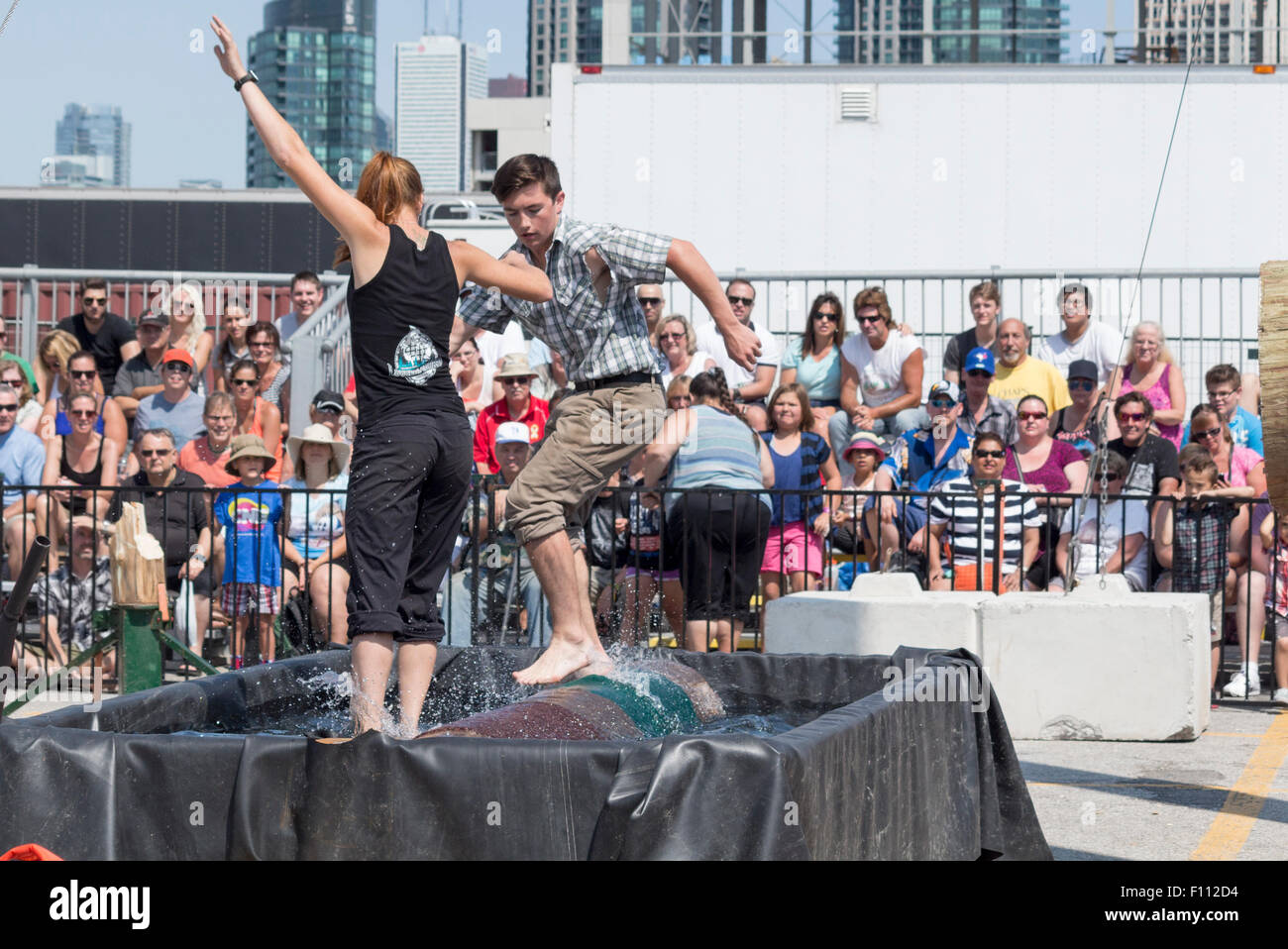 A lumberjack and a lumberjill compete in log rolling competition at the ...