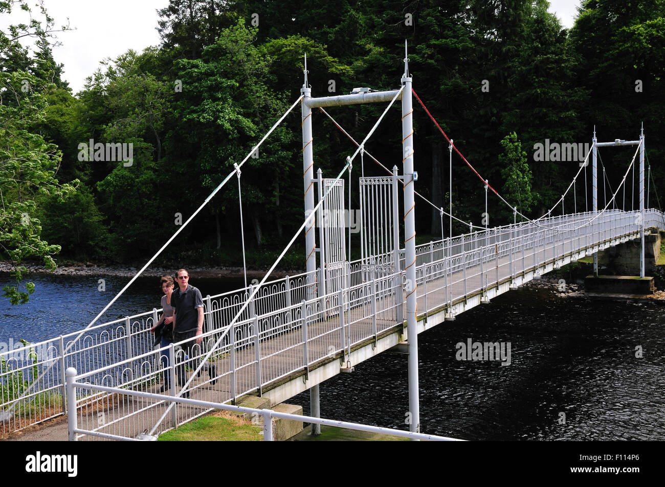 Couple walking on a pedestrian bridge connecting Ness Island and the ...