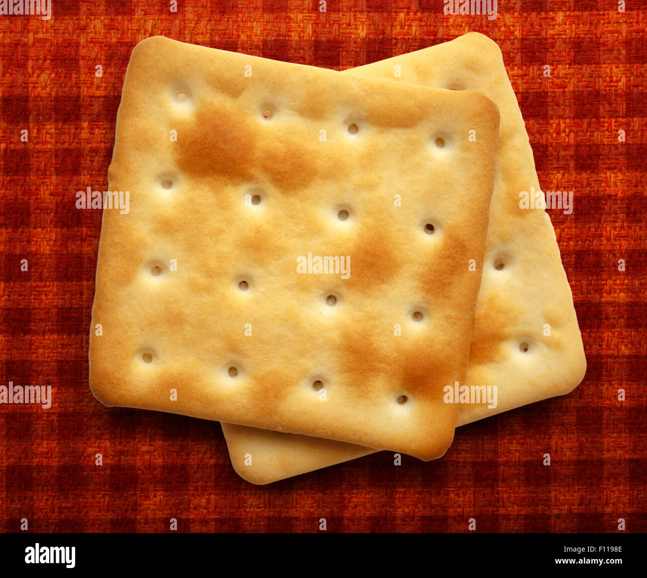 Blank square cookies on the red background Stock Photo - Alamy