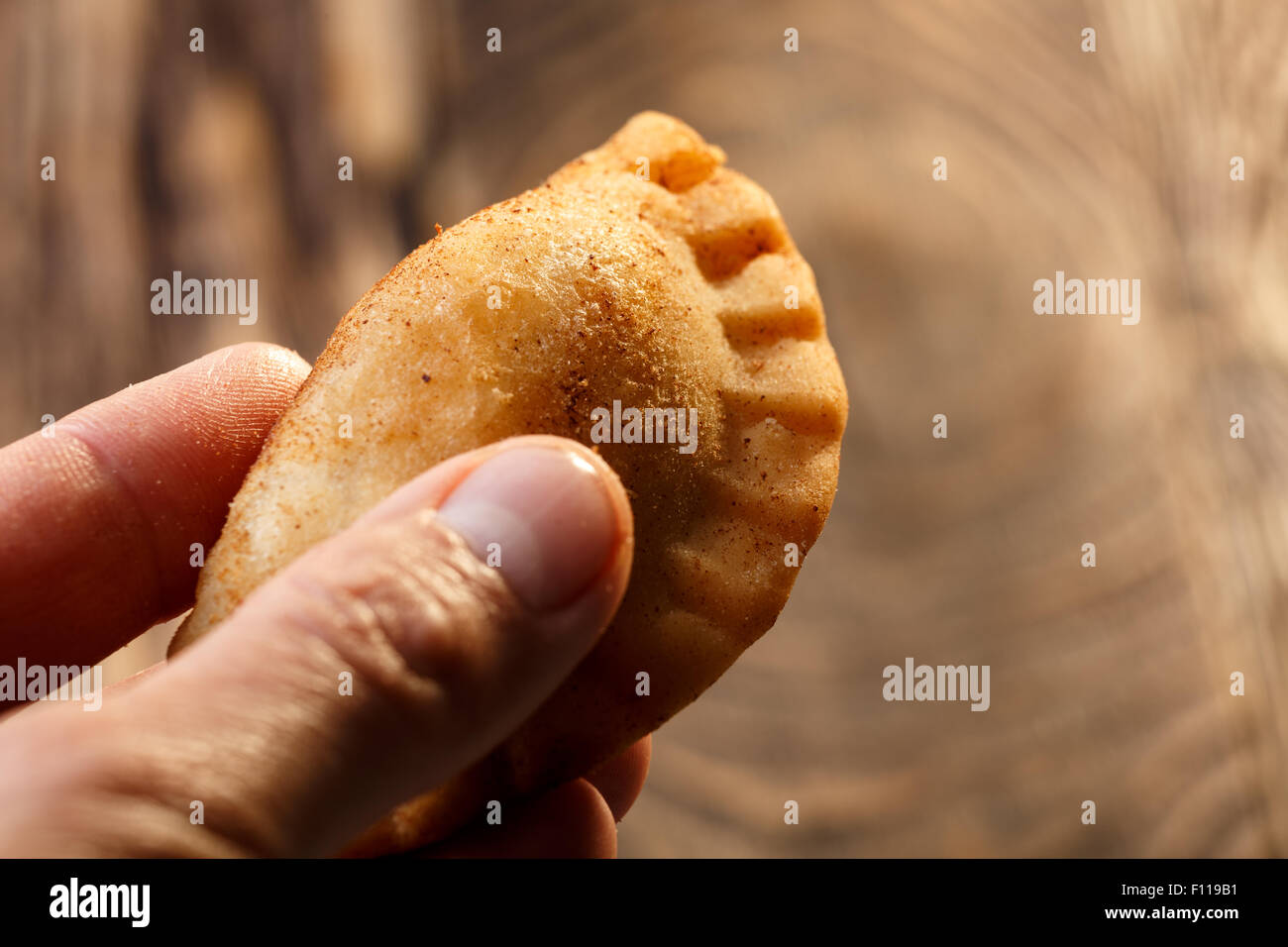 Male hand holding fried colombian empanada. Savory stuffed patties also ...