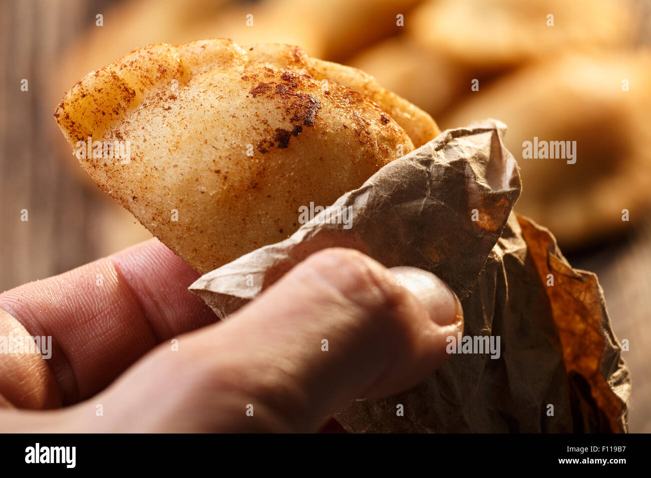 Male hand holding fried colombian empanada. Savory stuffed patties also ...