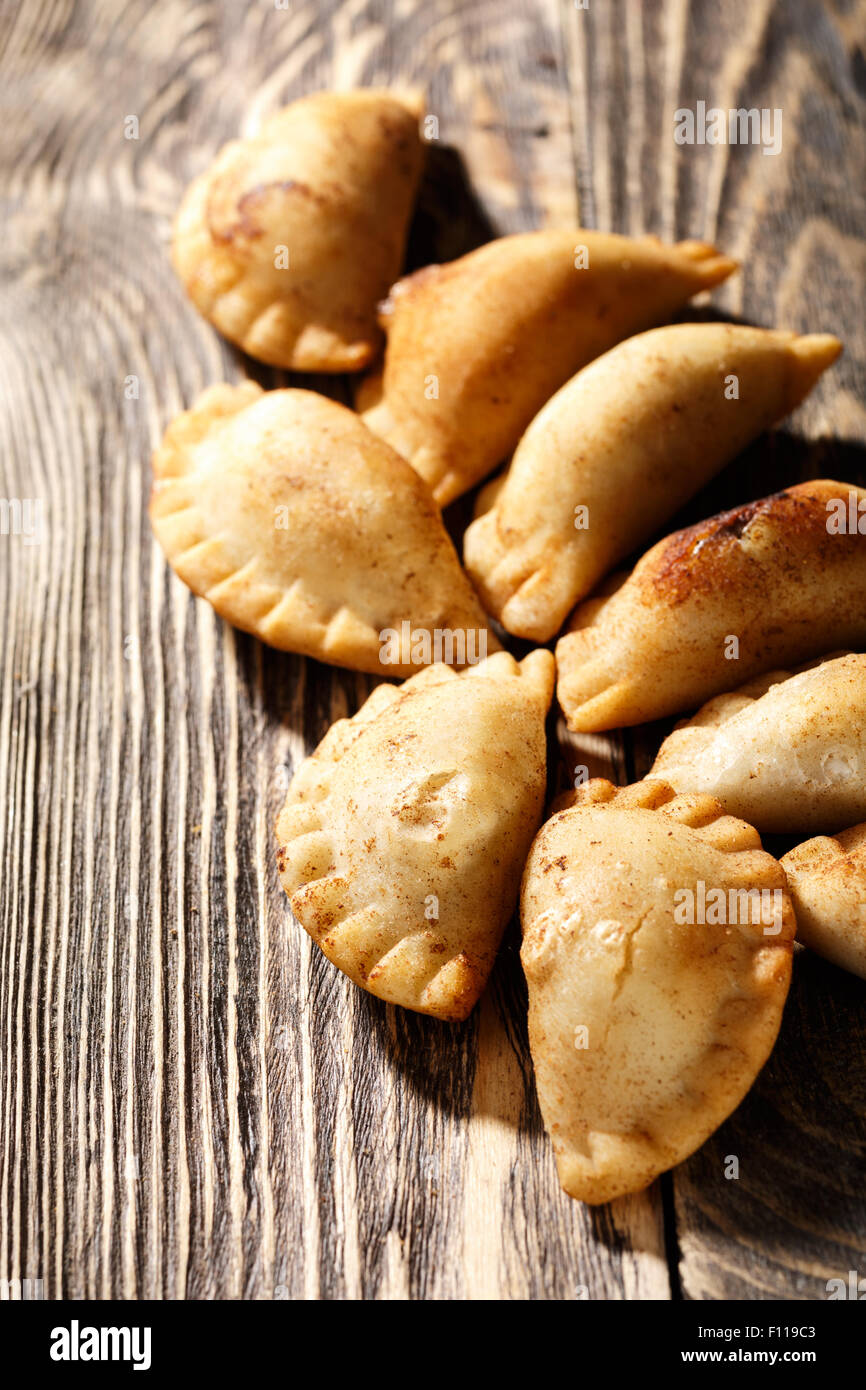 Fried colombian empanadas on wooden table. Savory stuffed patties also ...