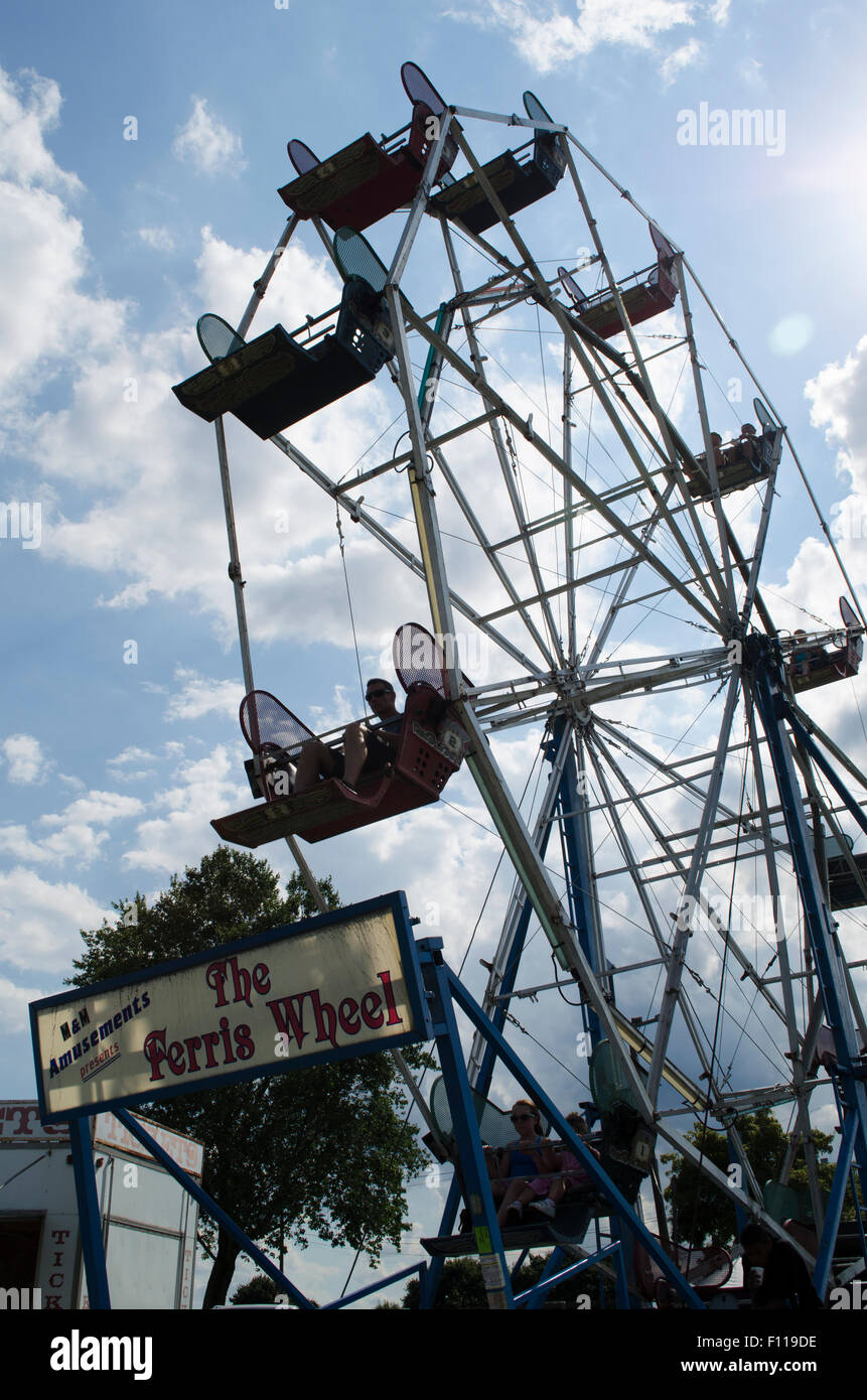 Ferris wheel ride backlit by sun at county fair Stock Photo - Alamy