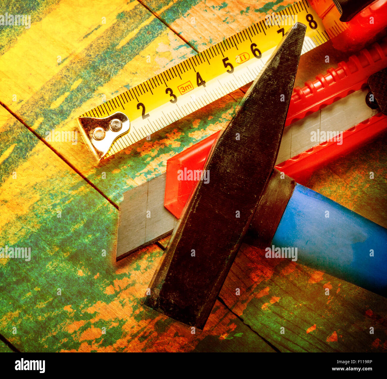 Tape measure, hammer and knife on wooden background Stock Photo - Alamy