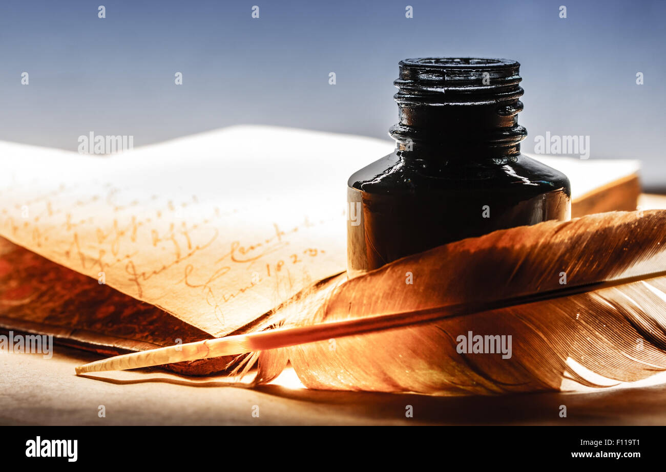 Old book with feather pen and inkpot Stock Photo - Alamy