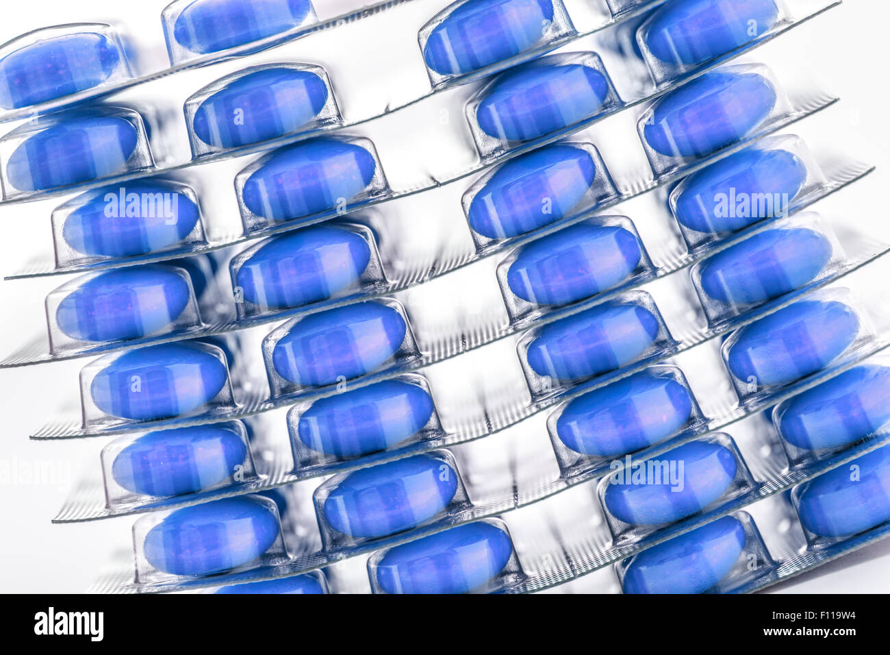 Colourful tablets in plastic packing as background Stock Photo - Alamy