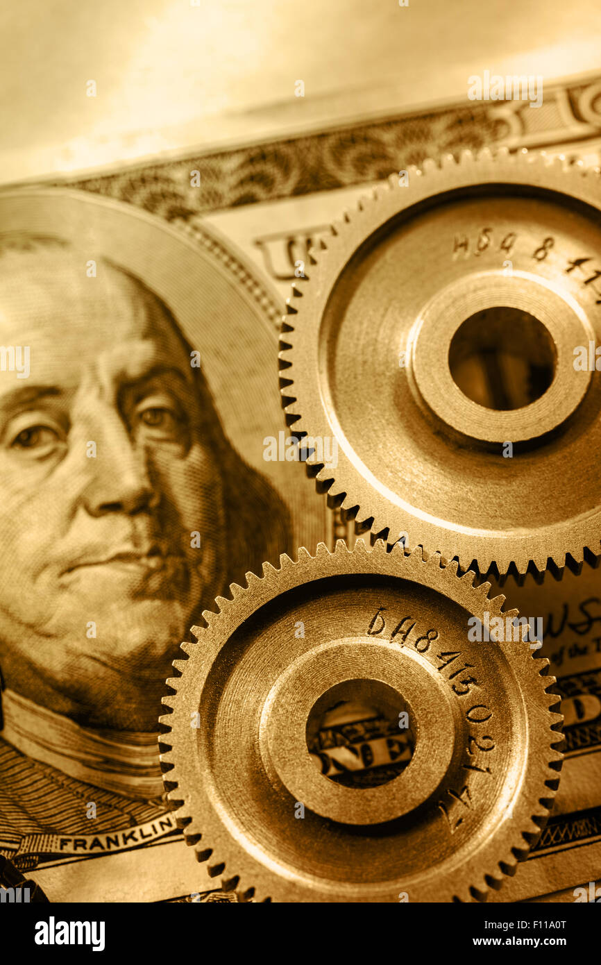 Mechanical ratchets and dollar in toning closeup Stock Photo - Alamy