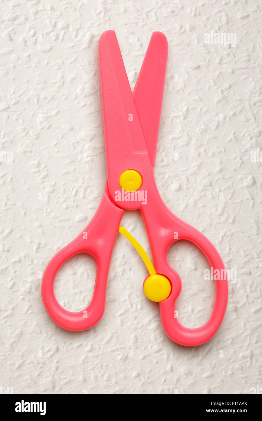 Pink safe children scissors on white background Stock Photo - Alamy