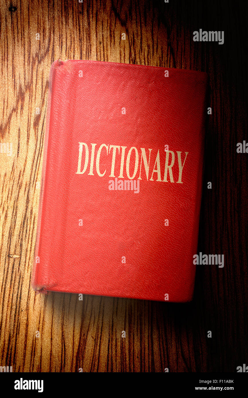 Old red dictionary on wooden textured background Stock Photo - Alamy