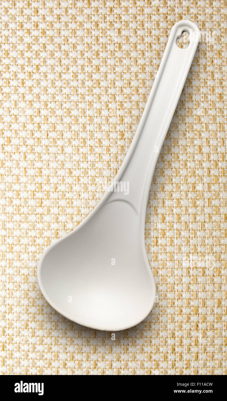 White plastic ladle on the cloth background Stock Photo - Alamy