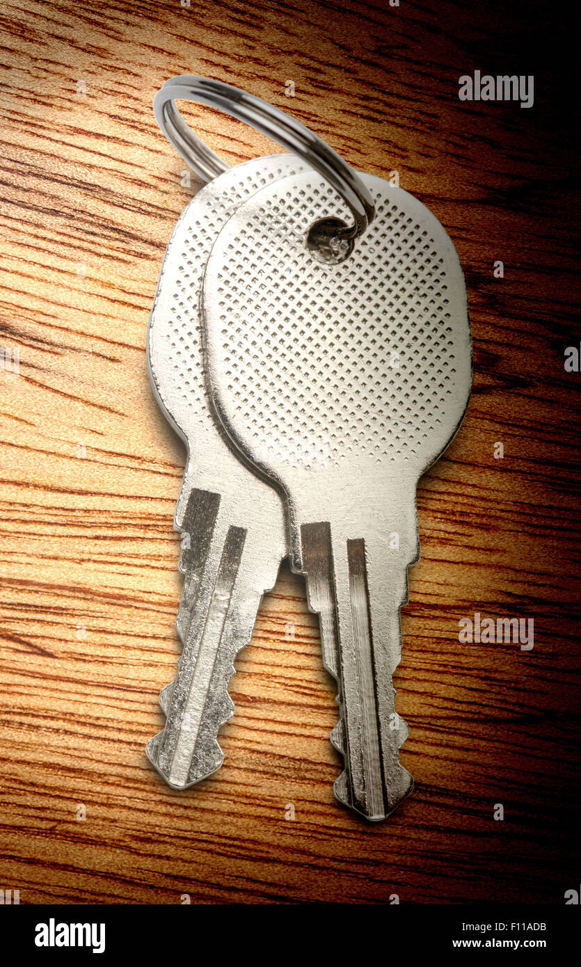 Two chrome keys on wooden background in closeup Stock Photo - Alamy
