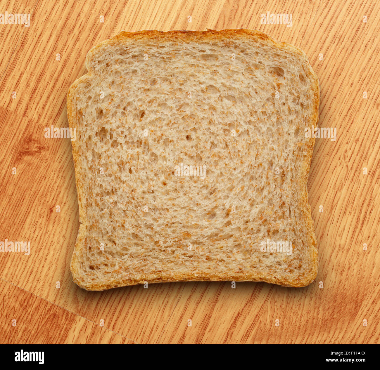 One bread slice on the wooden background Stock Photo - Alamy