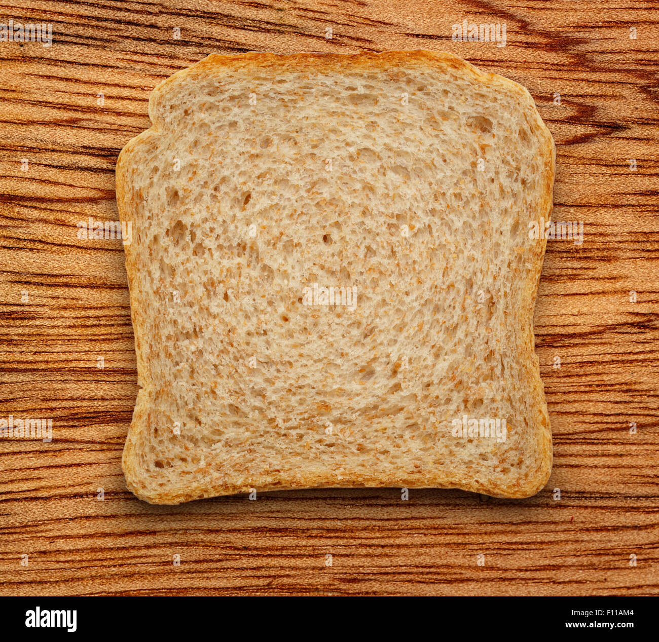 One bread slice on the wooden background Stock Photo - Alamy