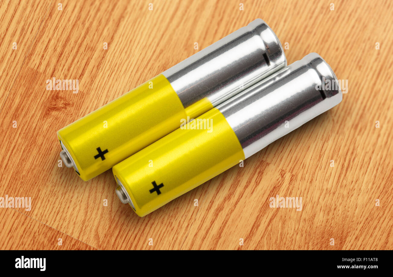Two batteries with plus sign visible in closeup Stock Photo - Alamy