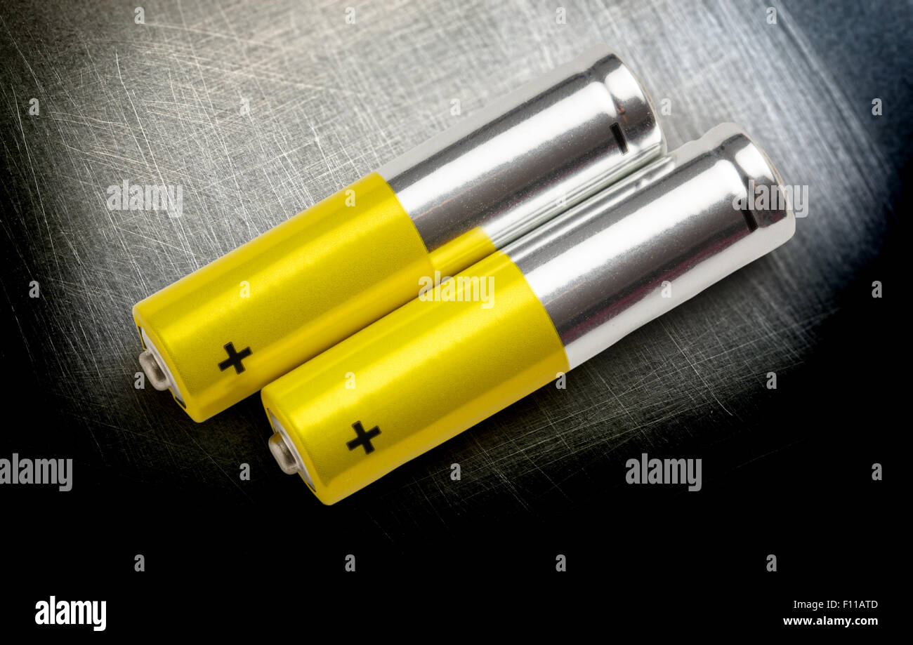 Two batteries with plus sign visible in closeup Stock Photo - Alamy