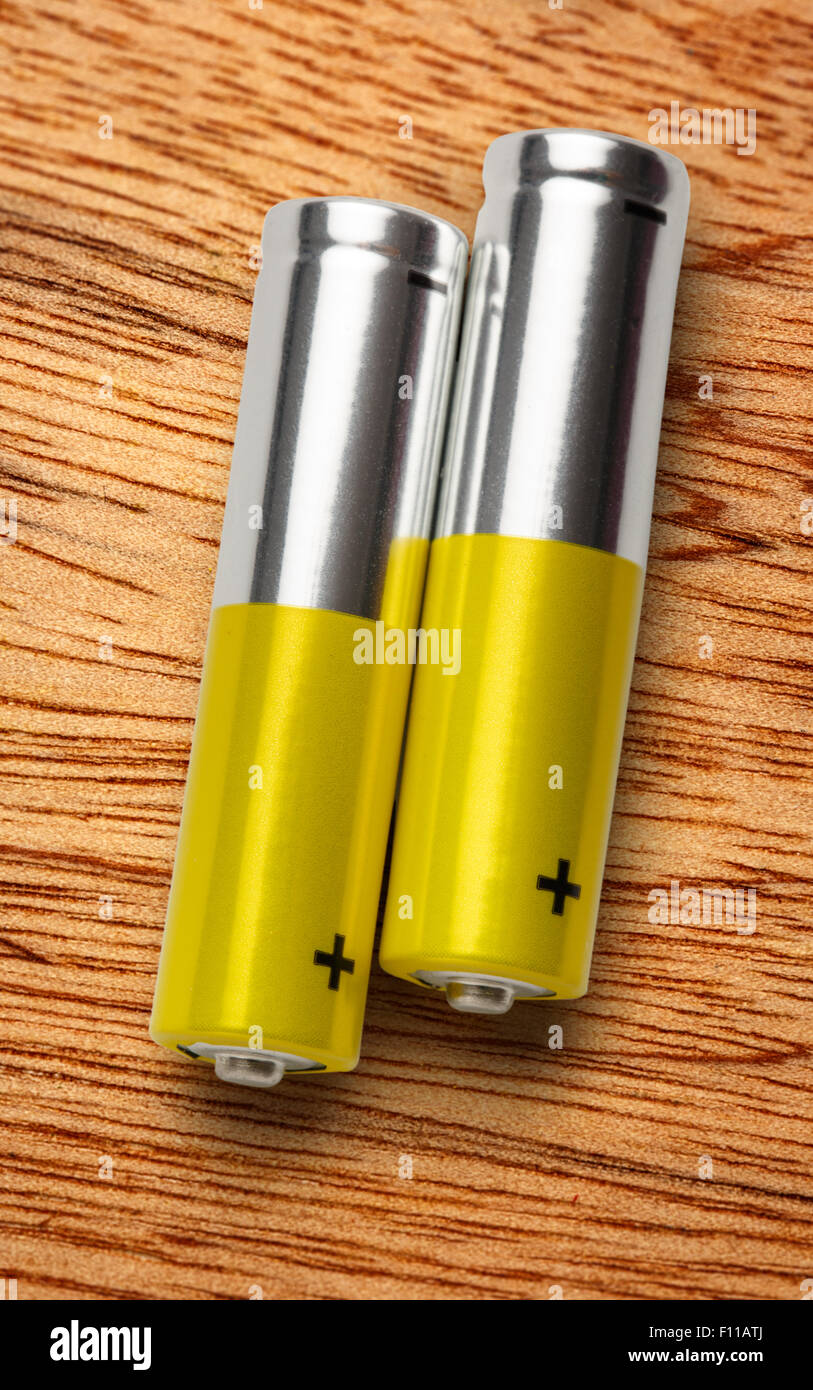 Two batteries with plus sign visible in closeup Stock Photo - Alamy