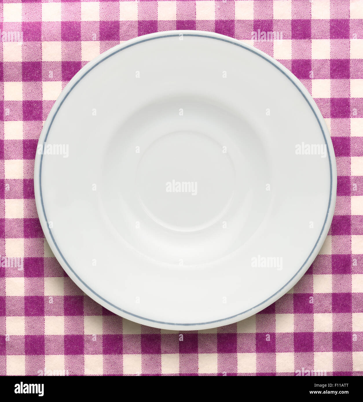 White plate in closeup on cloth background Stock Photo - Alamy