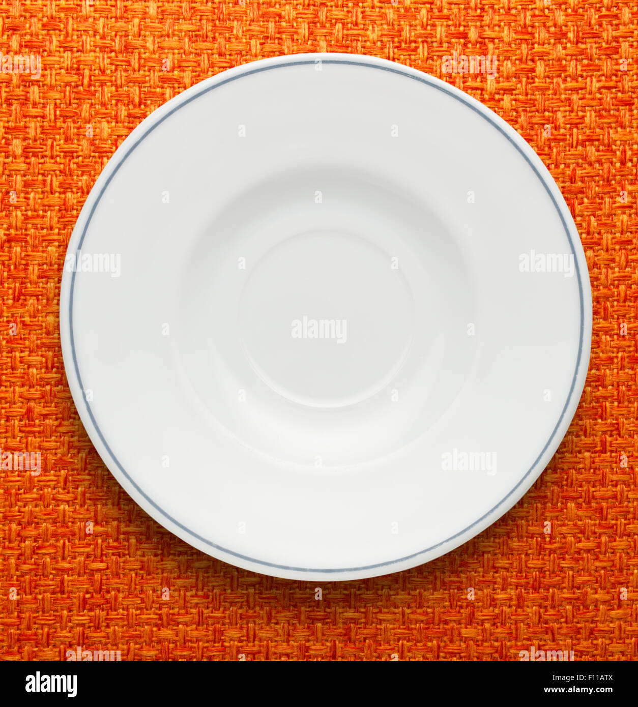 White plate in closeup on cloth background Stock Photo - Alamy