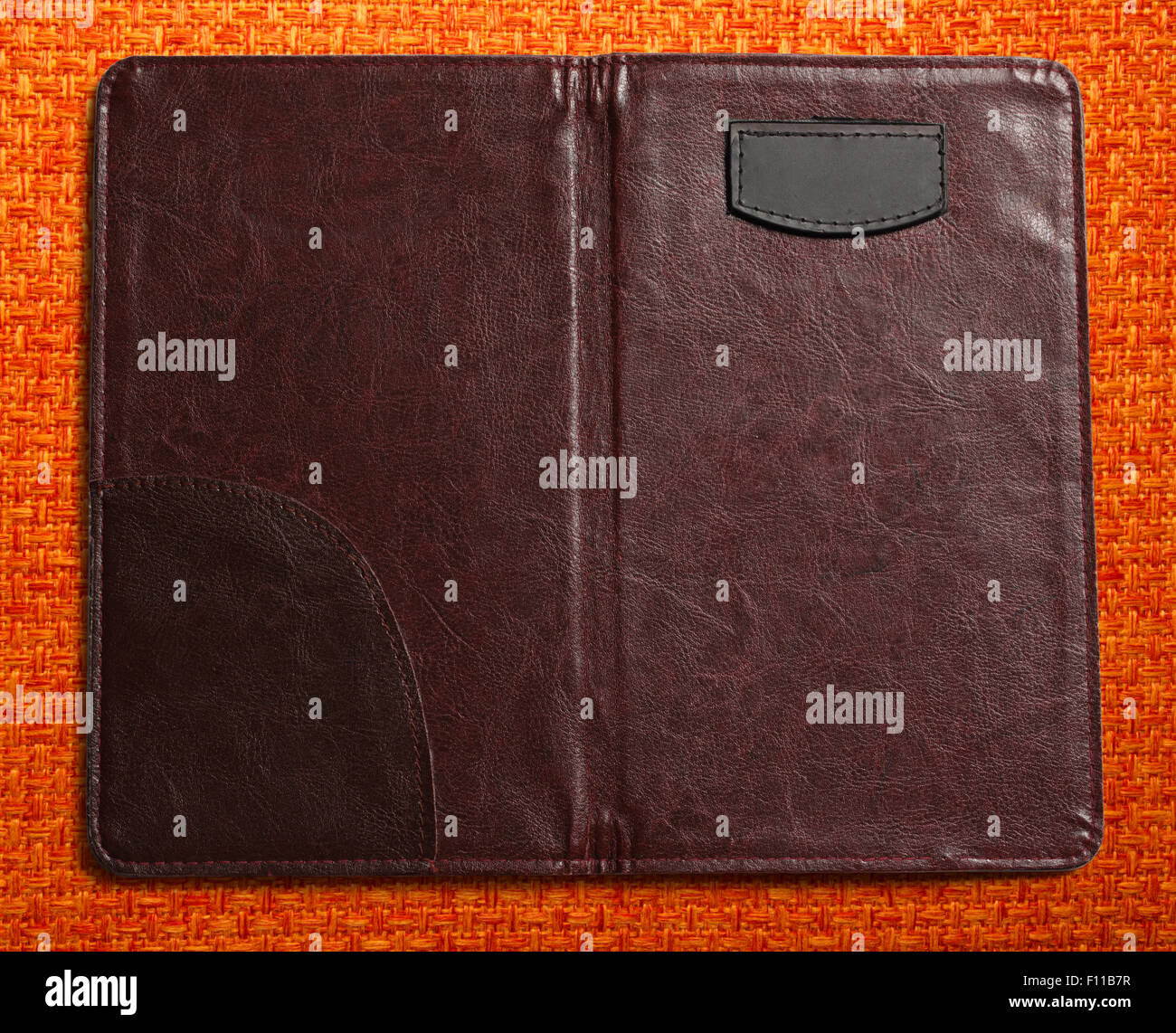 Open blank folder on orange textile background Stock Photo - Alamy