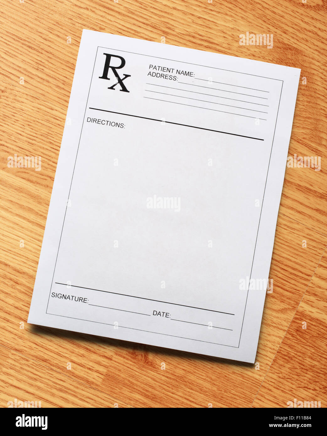 Single blank patient list on wooden background Stock Photo - Alamy