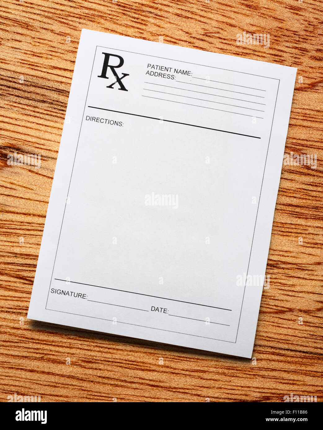 Single blank patient list on wooden background Stock Photo - Alamy