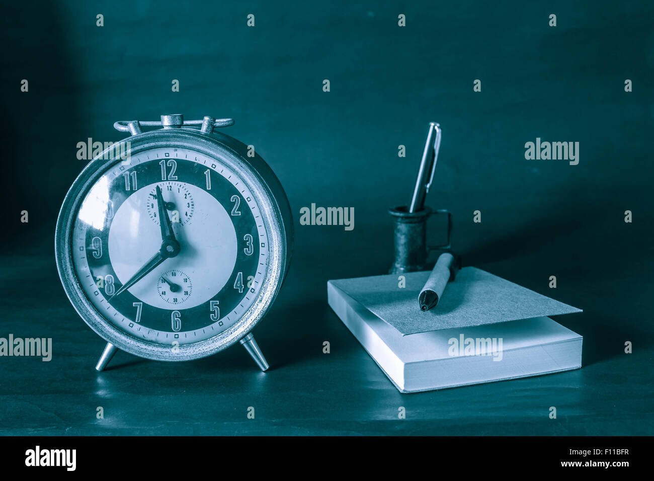 Clock and writing on a background Stock Photo - Alamy
