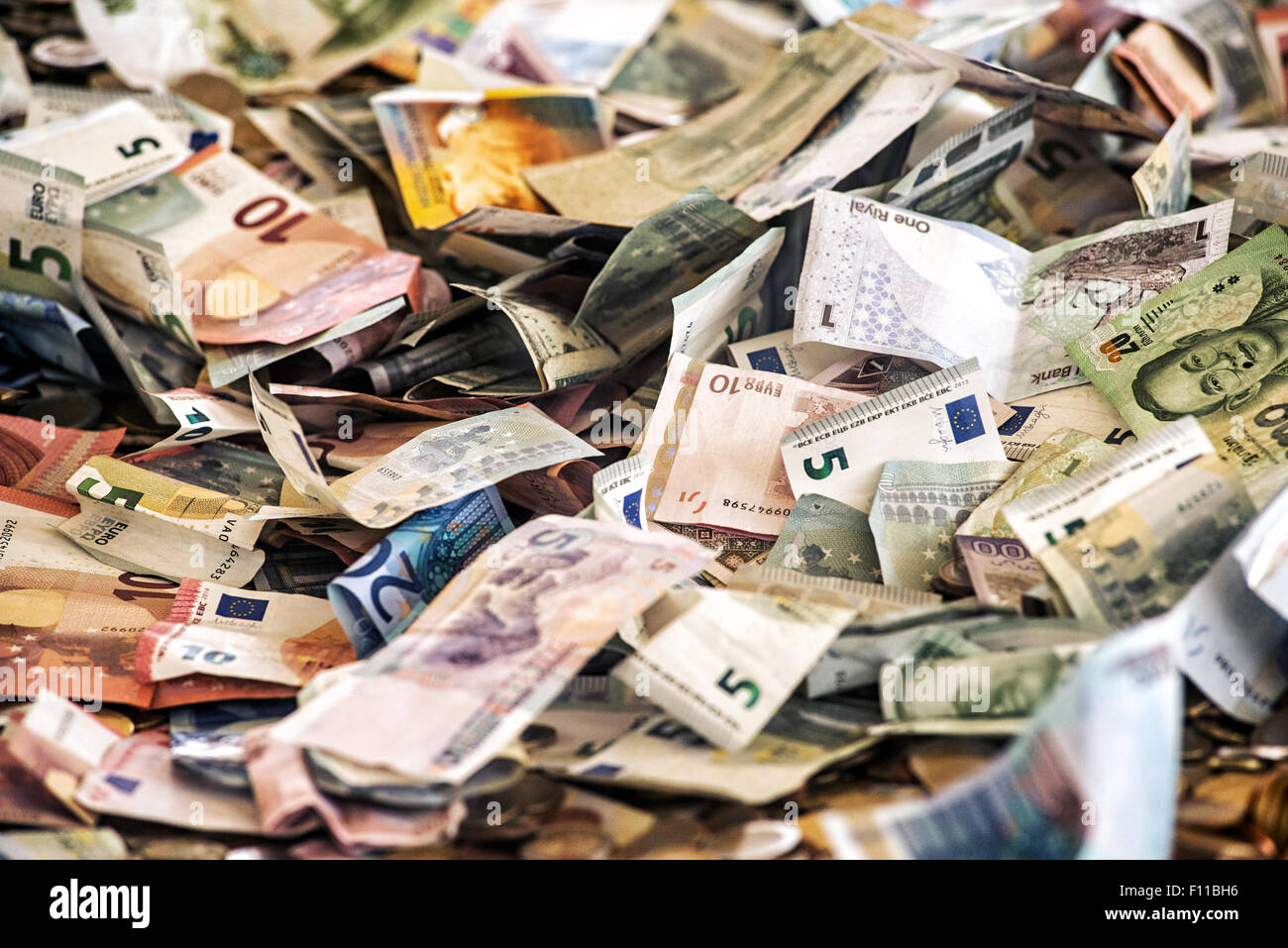 Money background of a heap of assorted banknotes in different ...