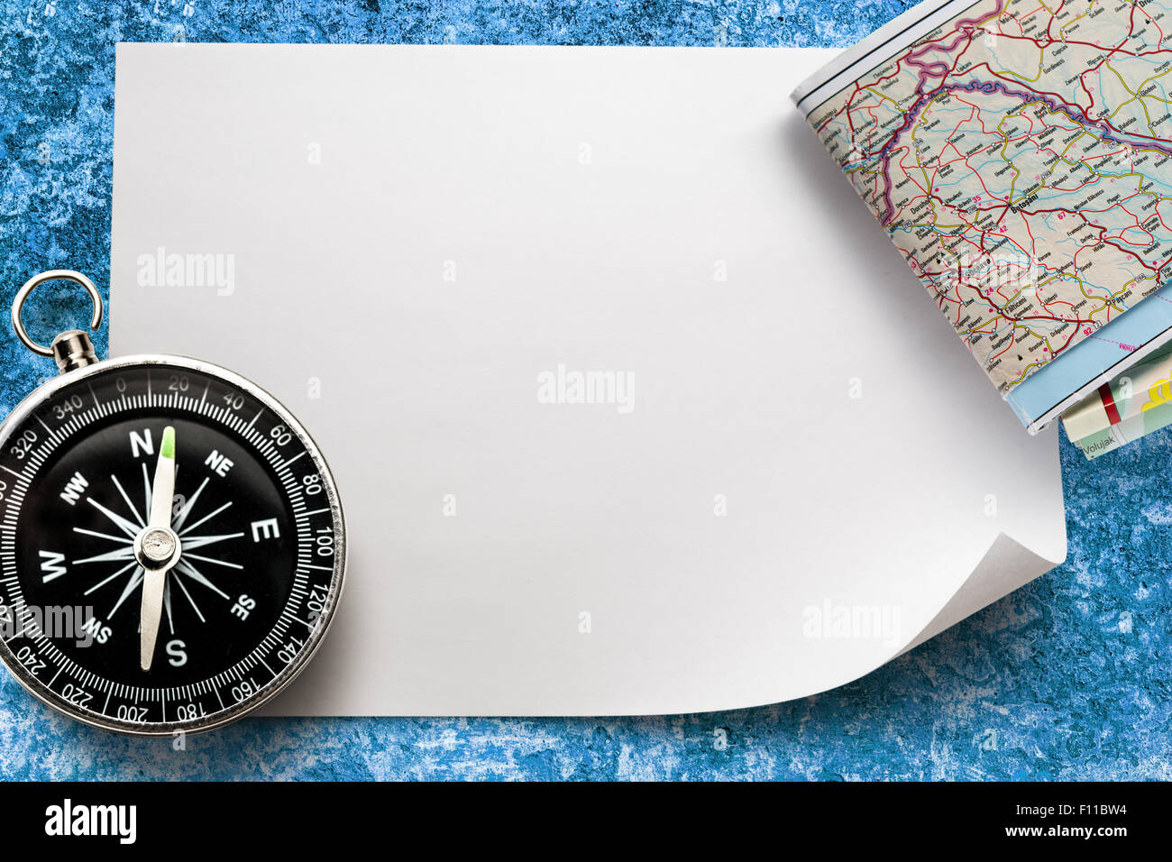 Compass with map on blank piece of paper Stock Photo - Alamy