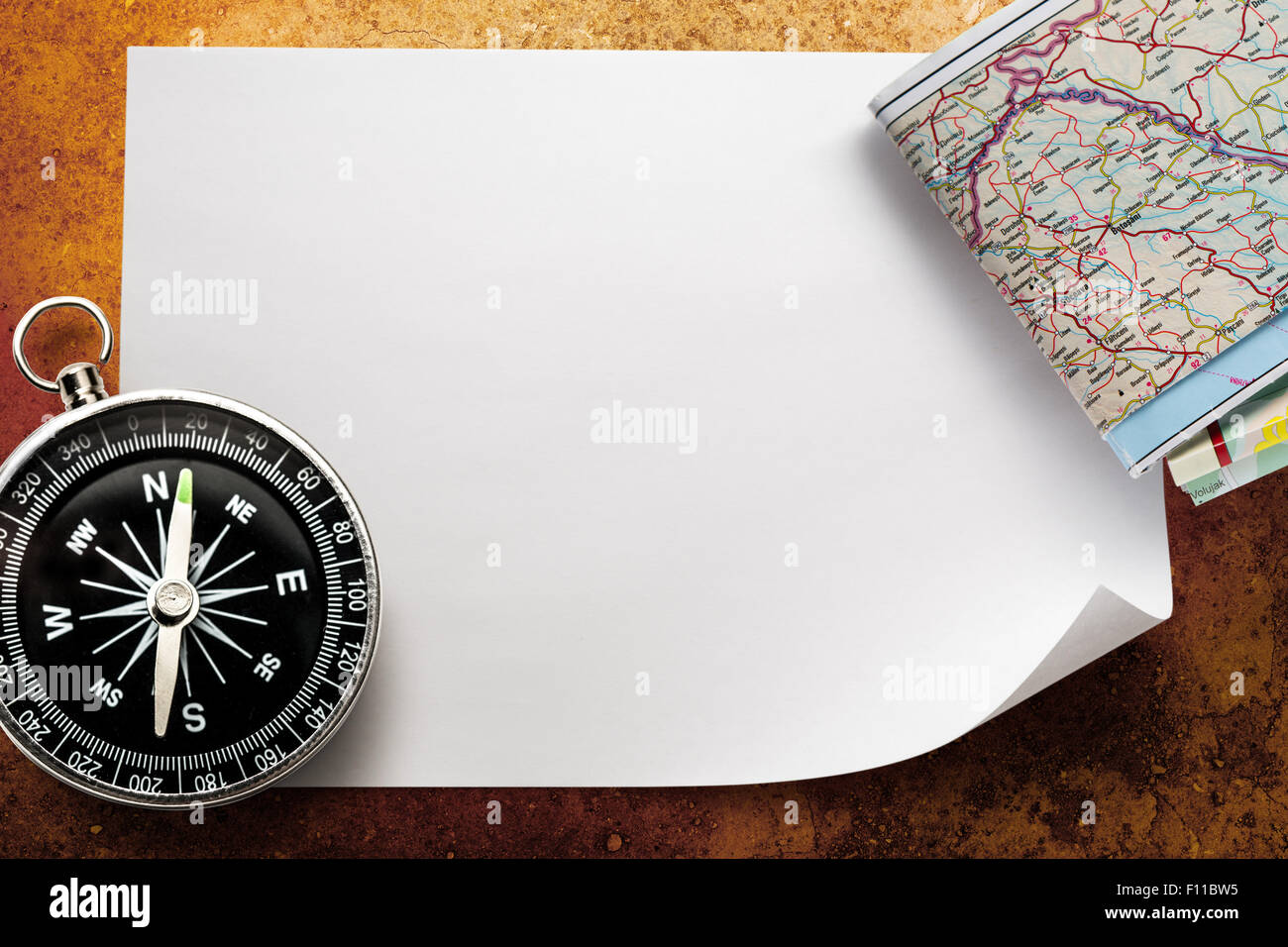 Compass with map on blank piece of paper Stock Photo - Alamy