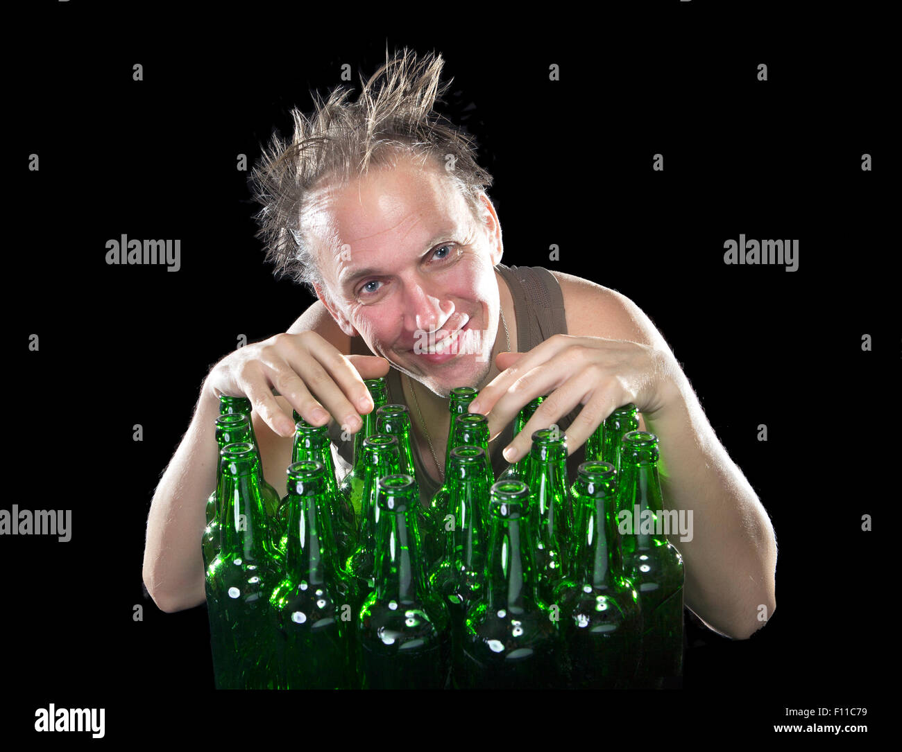 The happy tipsy man near empty beer bottles Stock Photo - Alamy