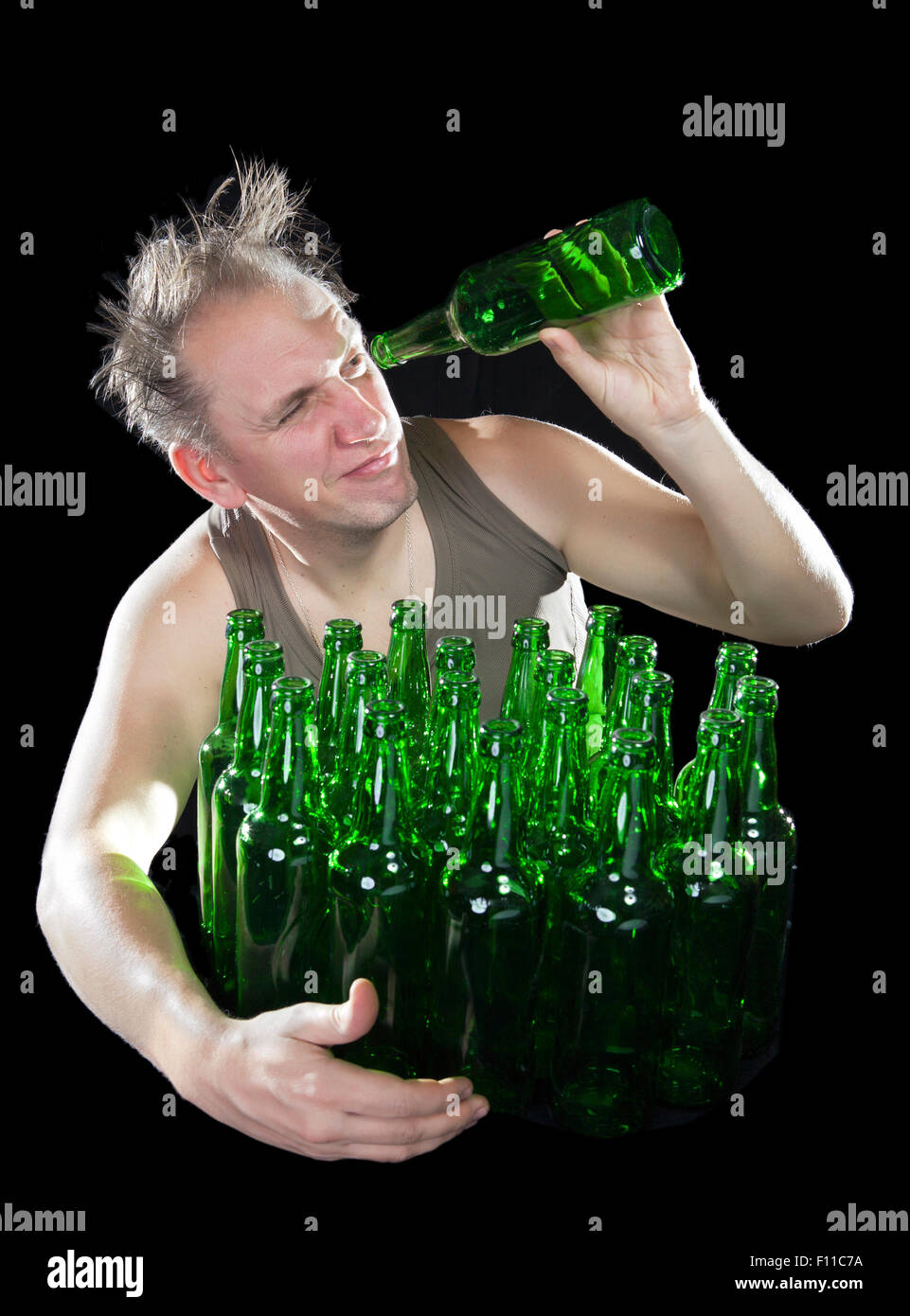 The happy tipsy man near empty beer bottles Stock Photo - Alamy