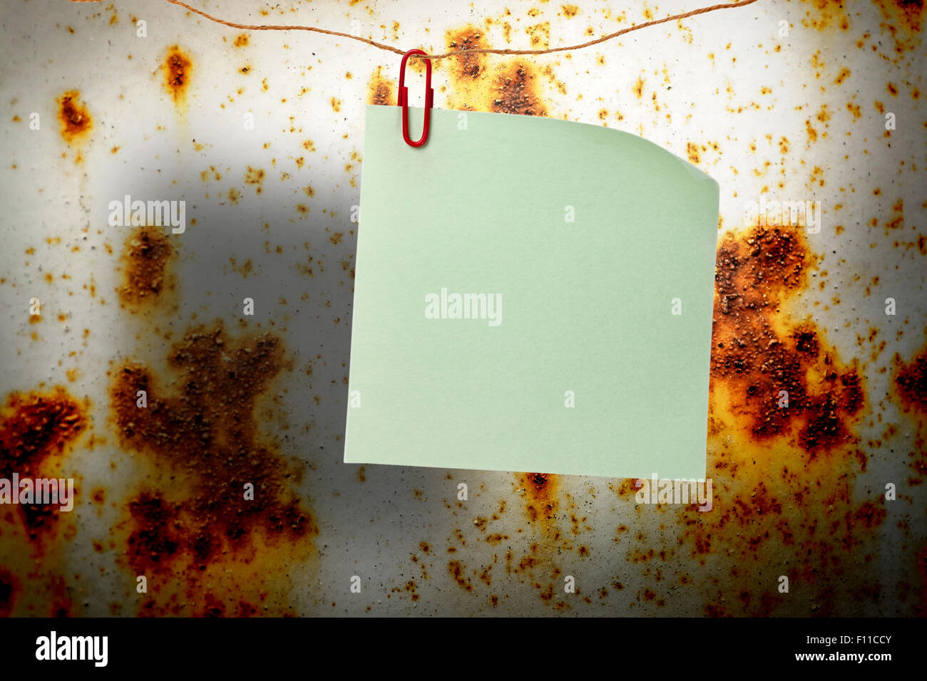 Blank green sticker and red clip on rusty surface Stock Photo - Alamy