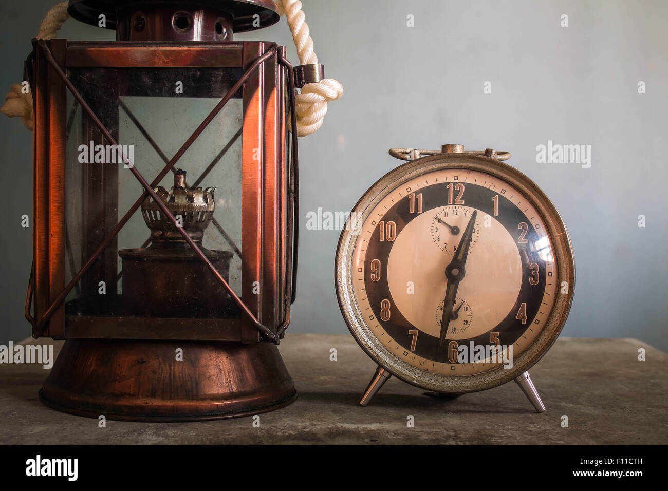 Old lamp and alarm clock on the table Stock Photo - Alamy