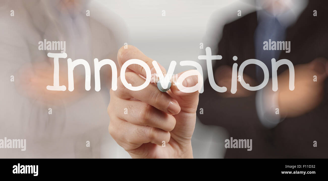 businessman hand writing innovation on touch screen computer as concept ... businessman hand writing innovation on touch screen computer as concept ...