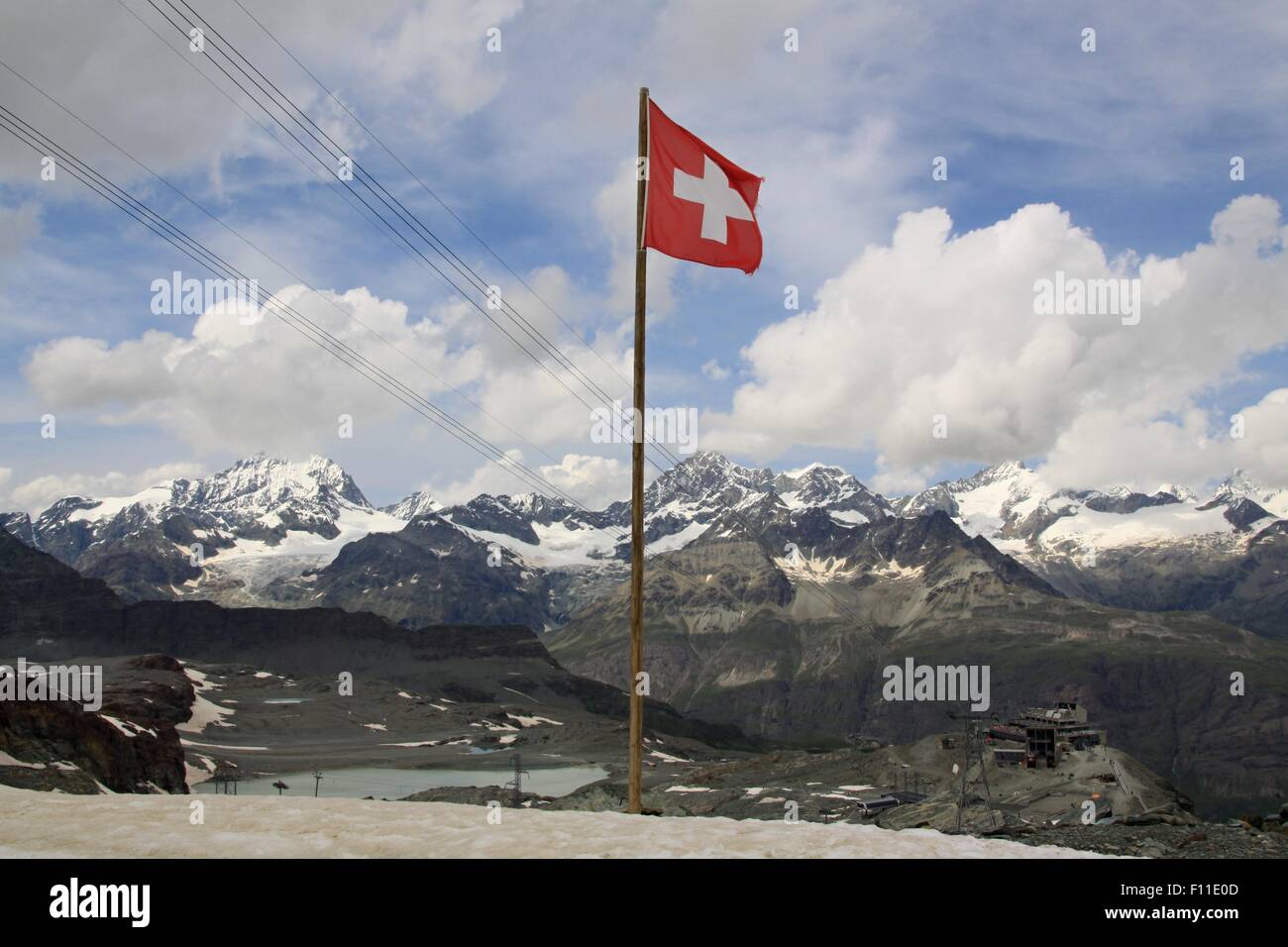 Swiss alps near mont Matterhorn and Swiss flag Stock Photo - Alamy