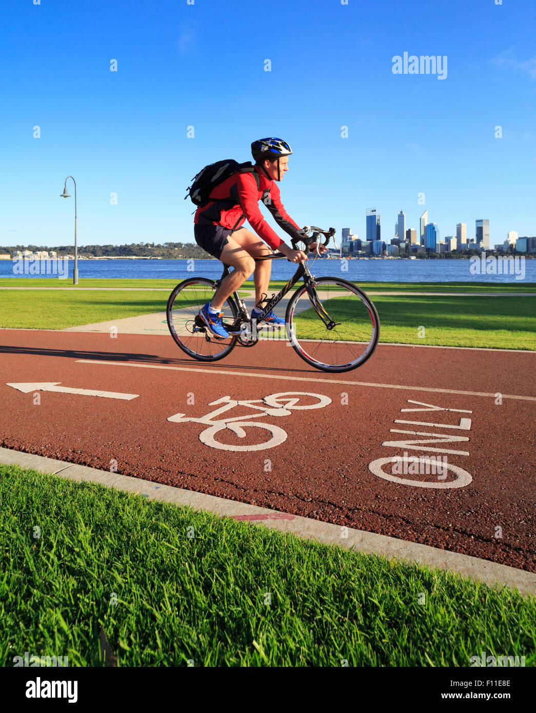 Male cyclist riding down a cycle only bike path / cycle lane with Perth ...