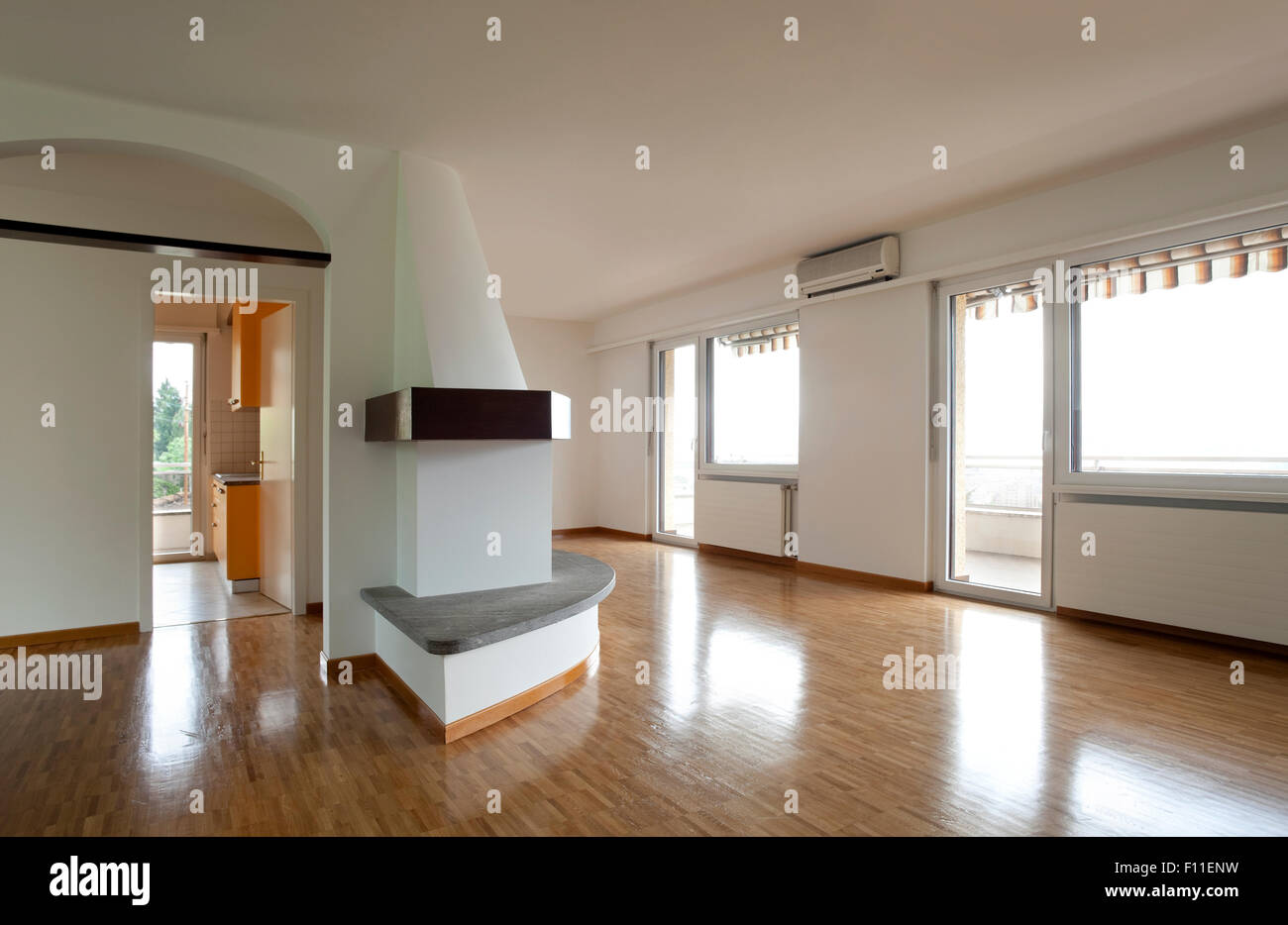 Modern apartment, interior. Empty living room with windows. Nobody ...