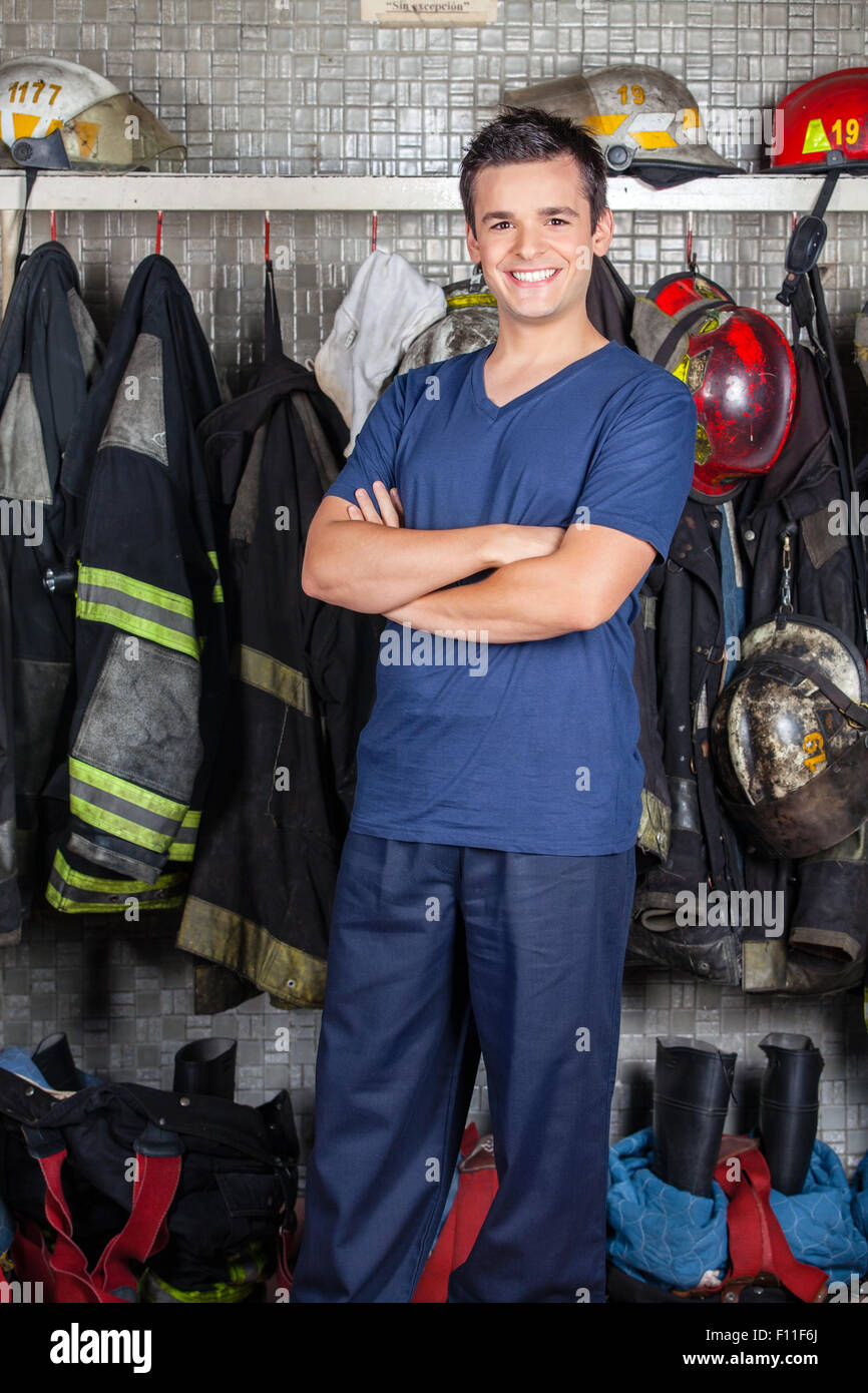 Happy Firefighter Standing At Fire Station Stock Photo - Alamy