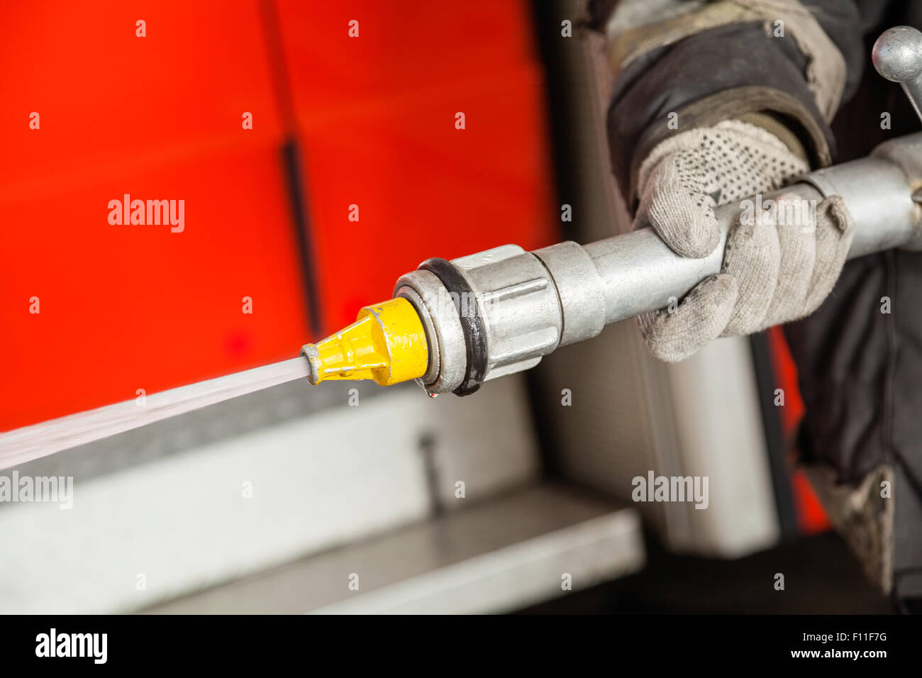 Fireman Spraying Water During Training Stock Photo - Alamy