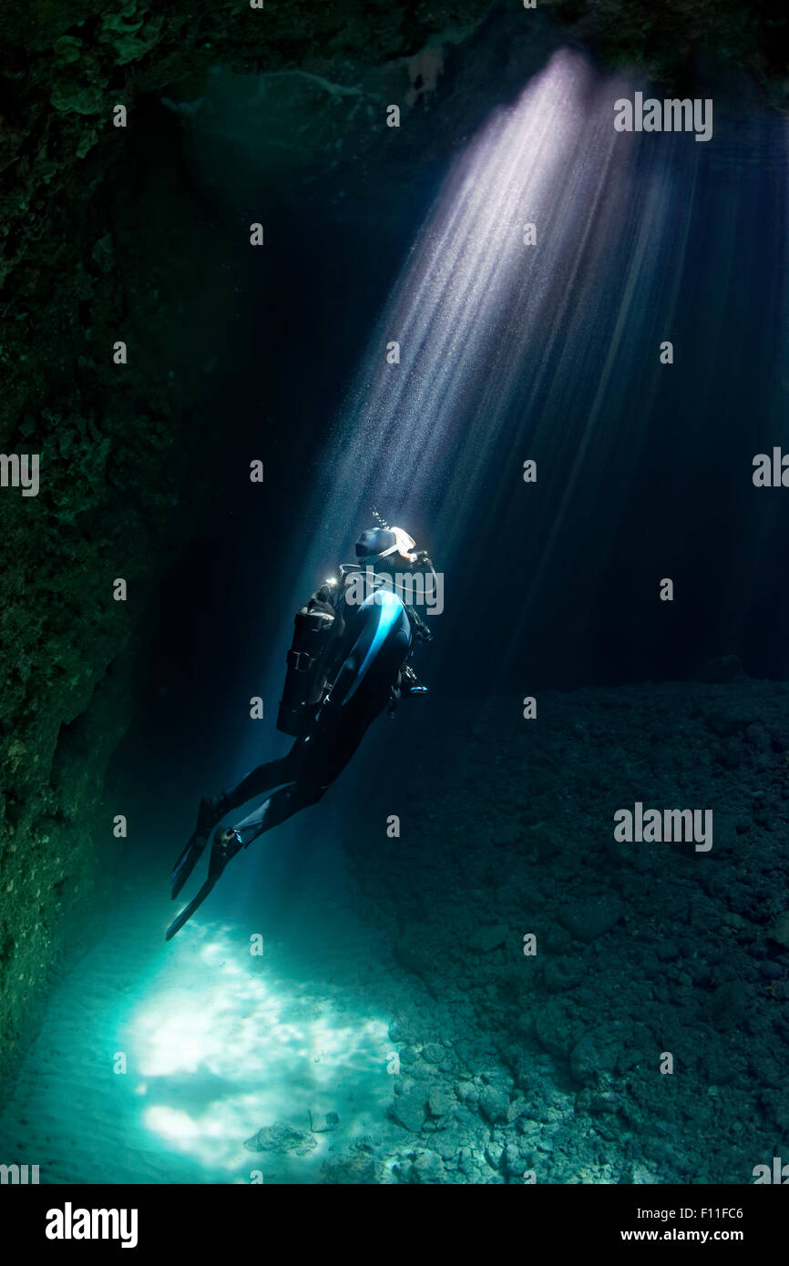 Diver in a cave, sun rays, island Corfu, Ionian Islands, Mediterranean ...